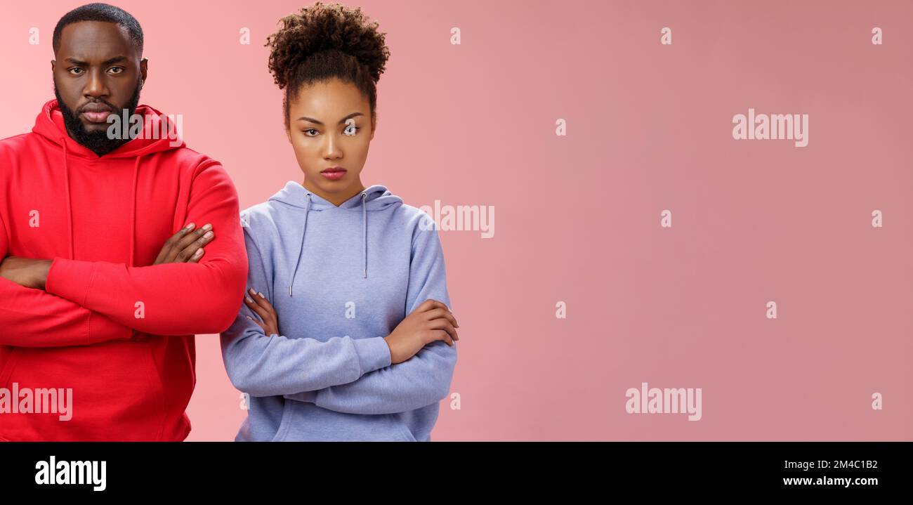 Two attractive african friends coworkers serious-looking standing ...