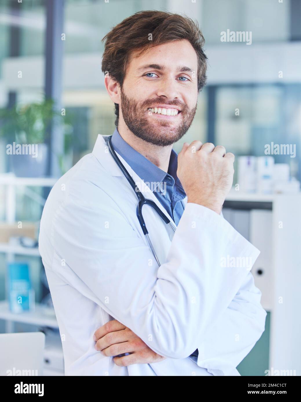 Portrait, man and doctor in hospital, smile and confident at work, wellness or healthcare for ...