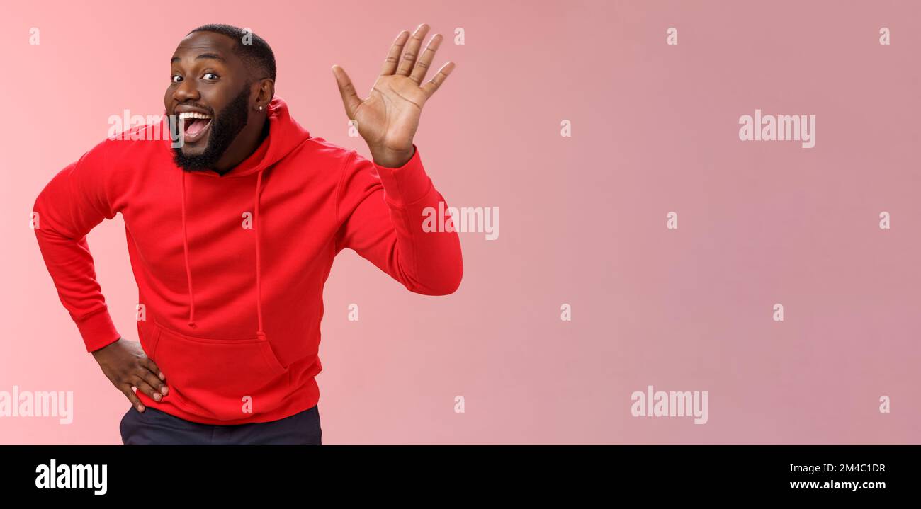Attractive funny african american gay beard in red hoodie raise palm ...
