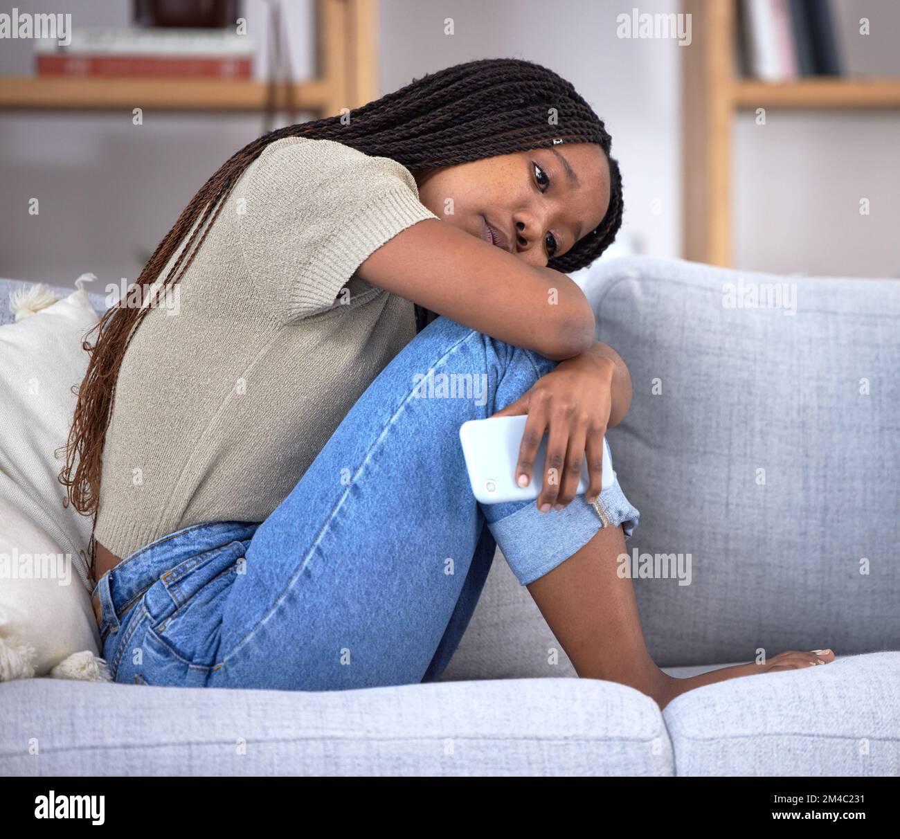 Breakup depression, sad and thinking black woman with a phone after communication, problem and ...