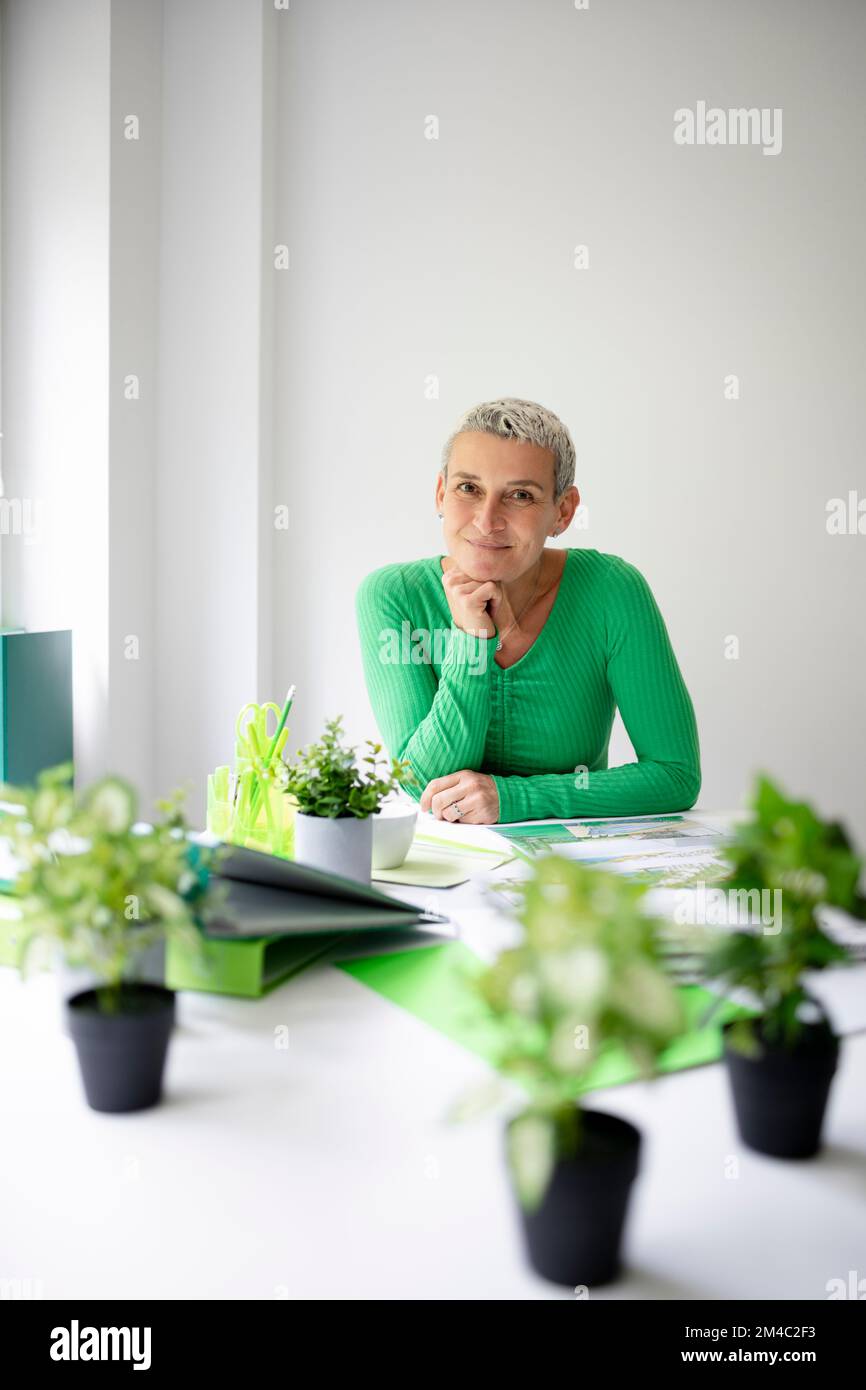 Landscape architect, garden architect is sitting in her modern green ...