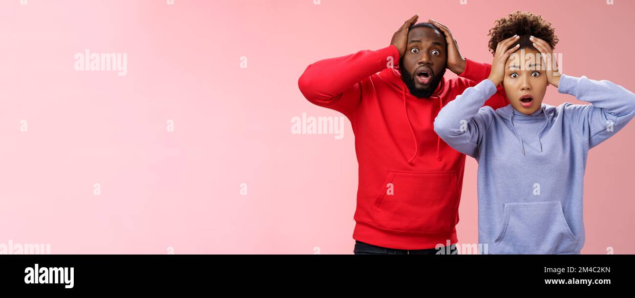 Shocked worried african american couple man woman holding hands head ...