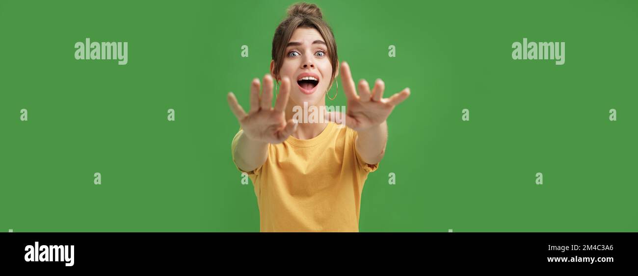 Excited and addicted goog-looking young woman reaching hands forward to ...