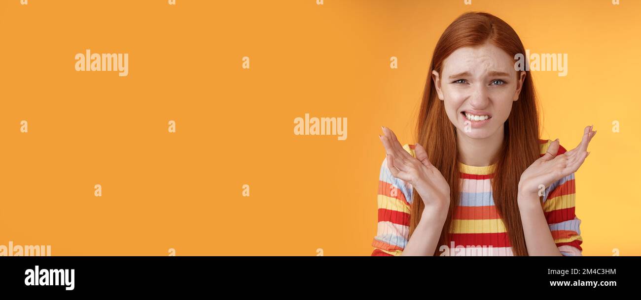 Awkward unhappy worried young redhead girl cringe feel sorry ...