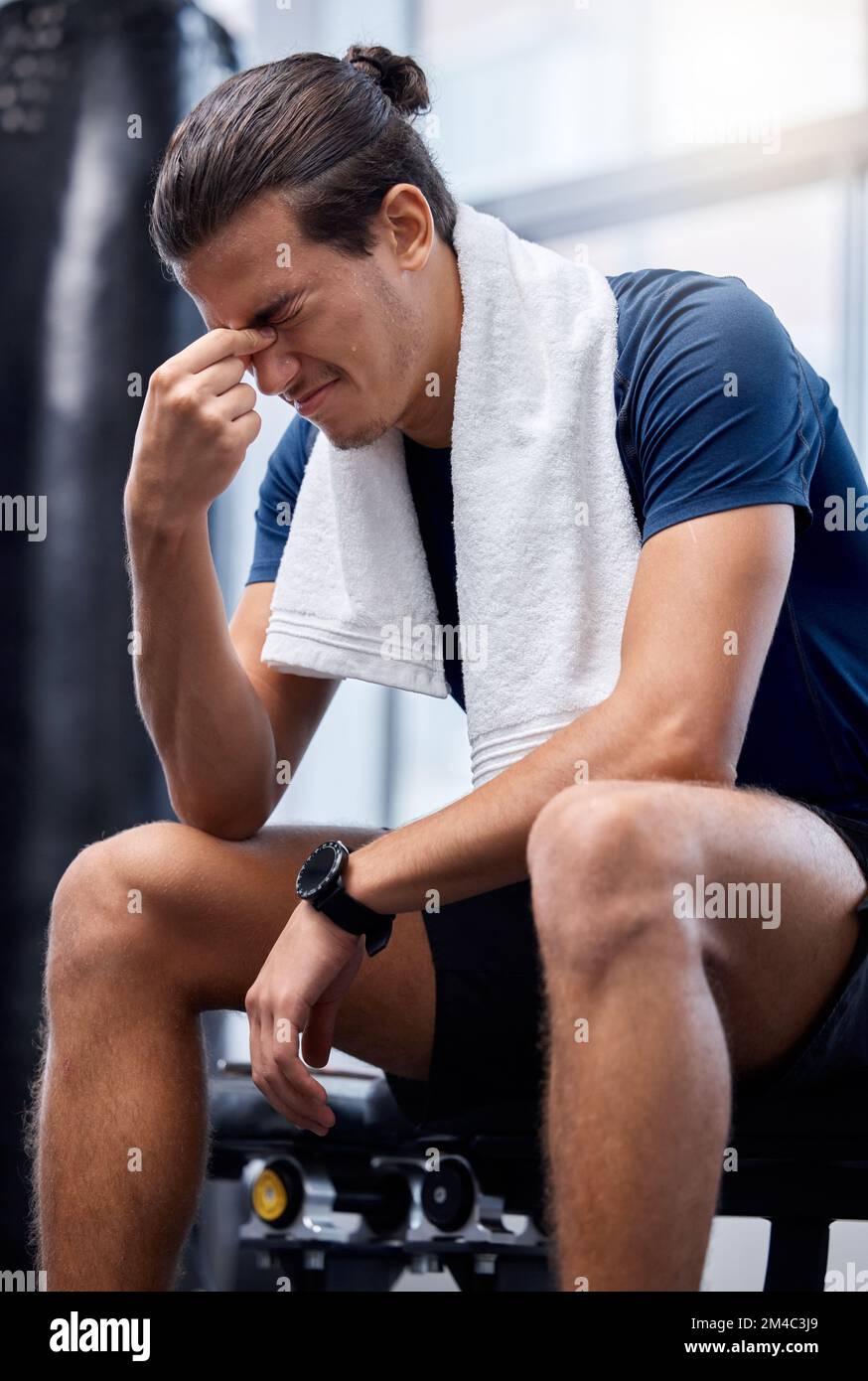 Man, gym exercise and tired with headache at training, workout or ...