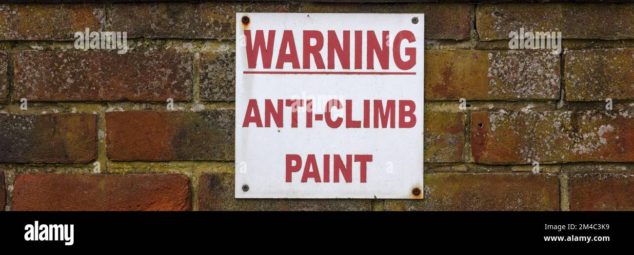 warning sign on brick wall for Anti-Climb paint in panorama format ...