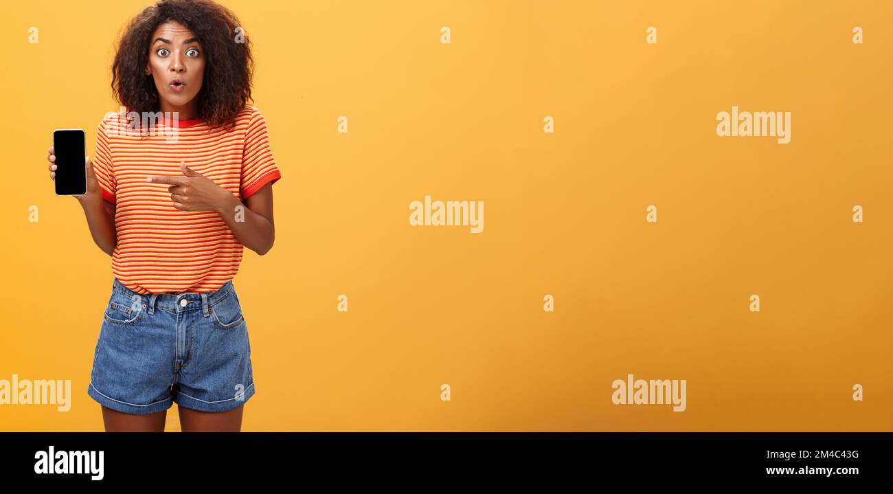 Portrait of impressed and curious female friend showing profile of ex ...