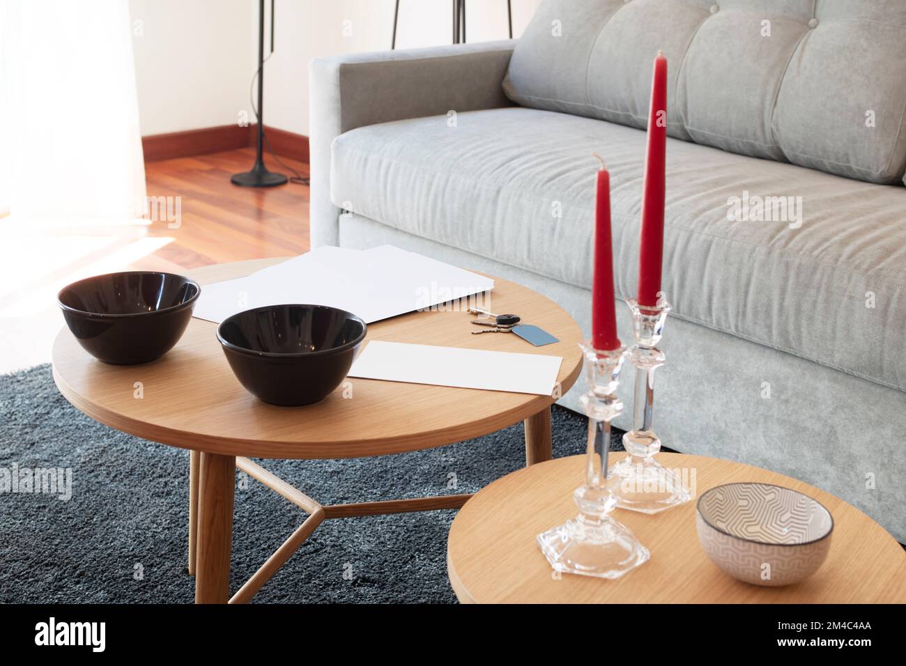 Living room with three-seater sofa upholstered in fabric and round ...