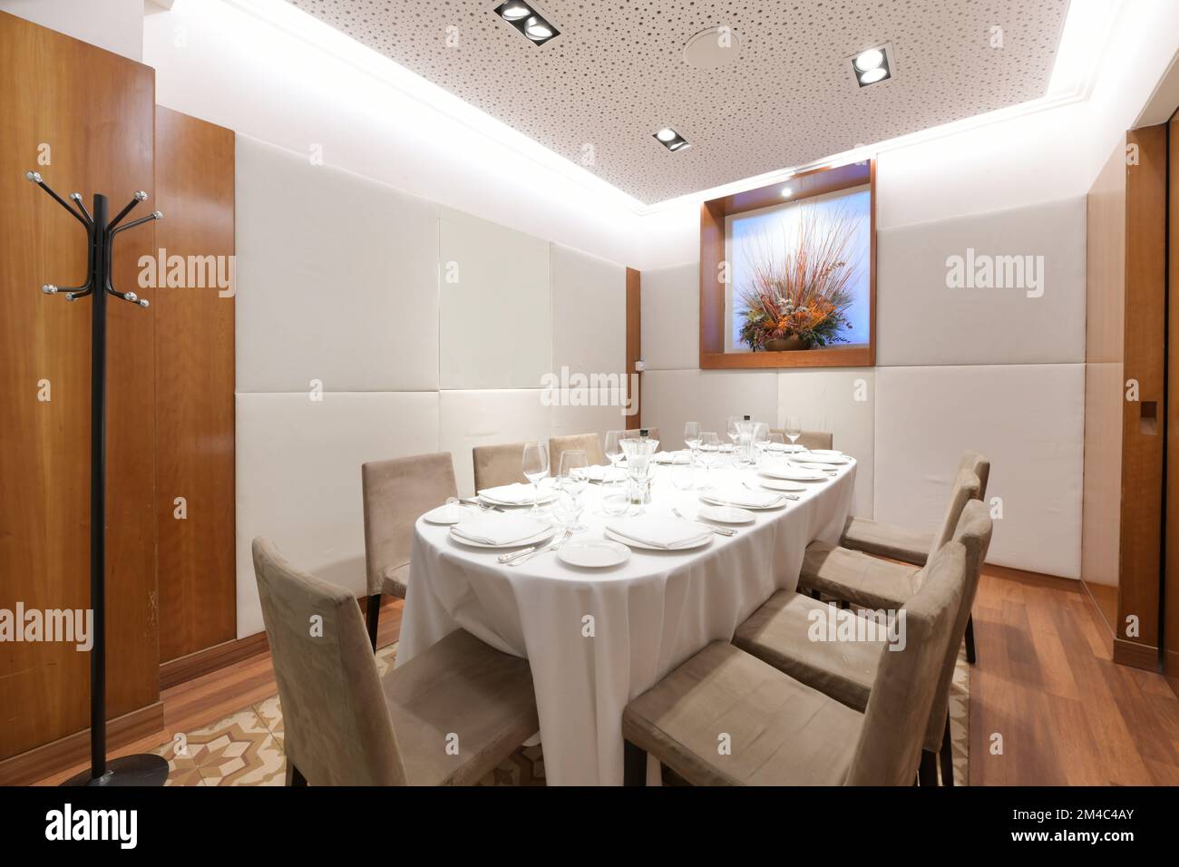 Dining table of a restaurant with a service of glasses and plates and a ...