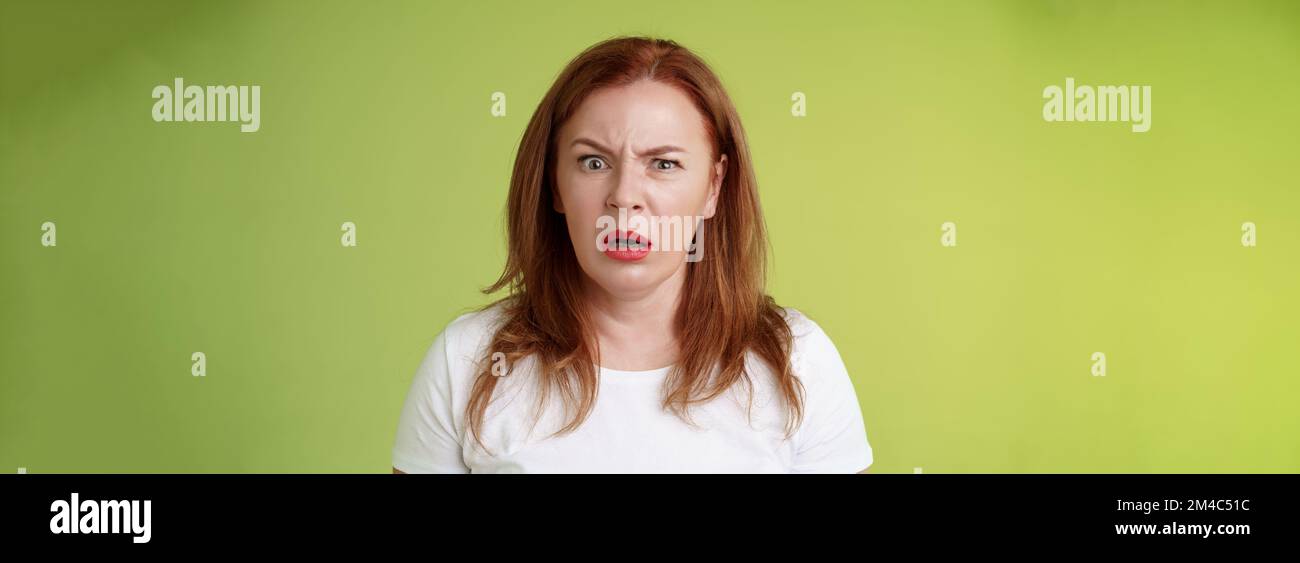 Confused shocked gasping middle-aged redhead woman cringe frustrated ...