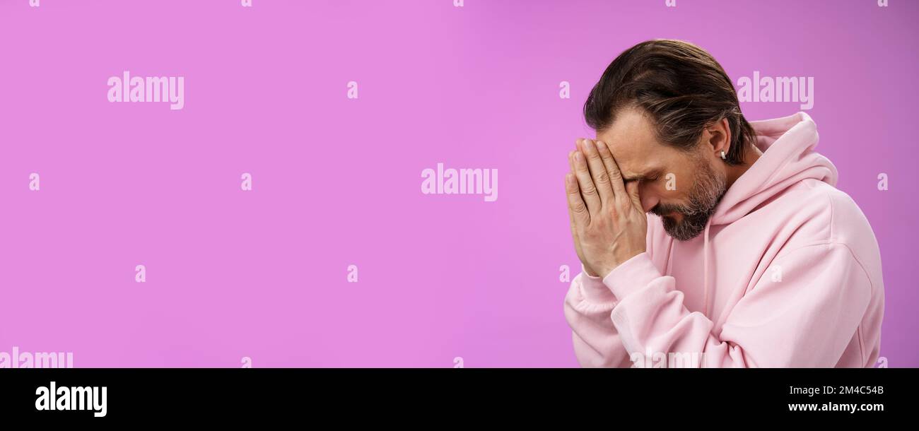 Concerned upset man supplicating asking god mercy help praying bow head ...