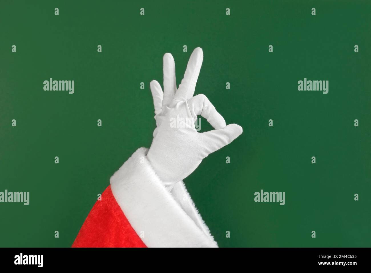 Santa Claus Hands Making Victory Sign and OK Gesture Isolated On Green ...