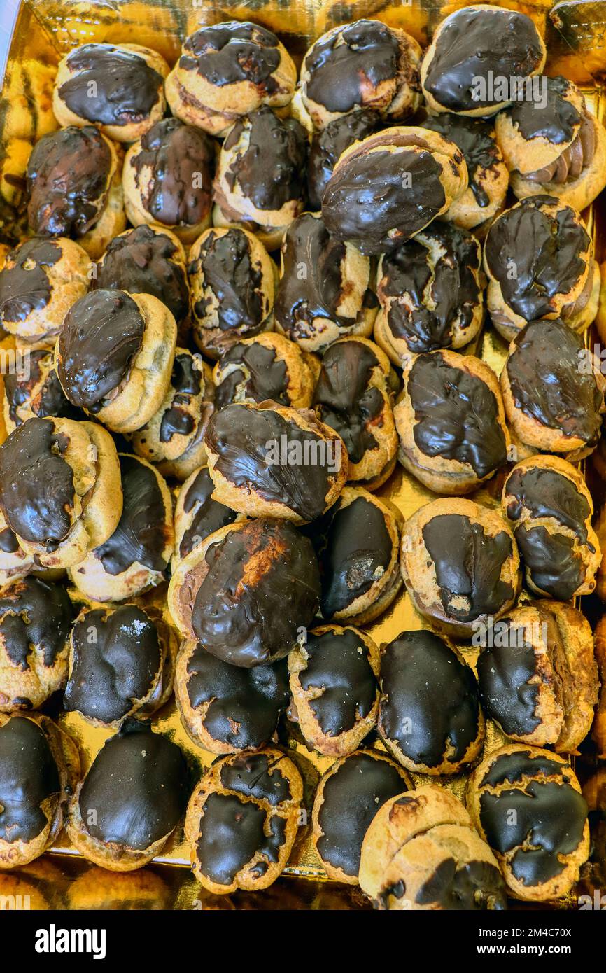 Tray with lots of chocolate cream puffs. Italian pastries Stock Photo ...