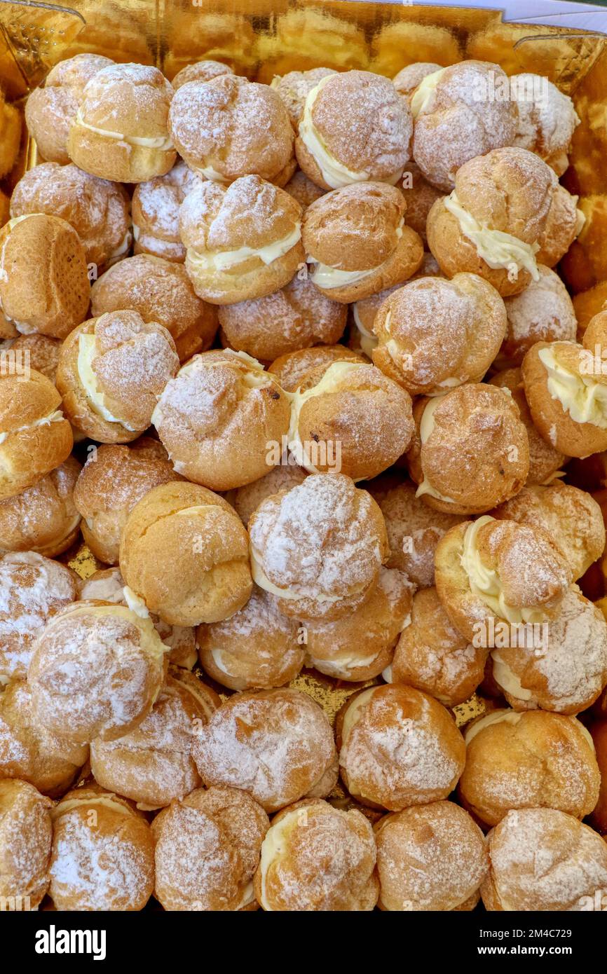 Tray with lots of cream puffs. Italian desserts Stock Photo - Alamy