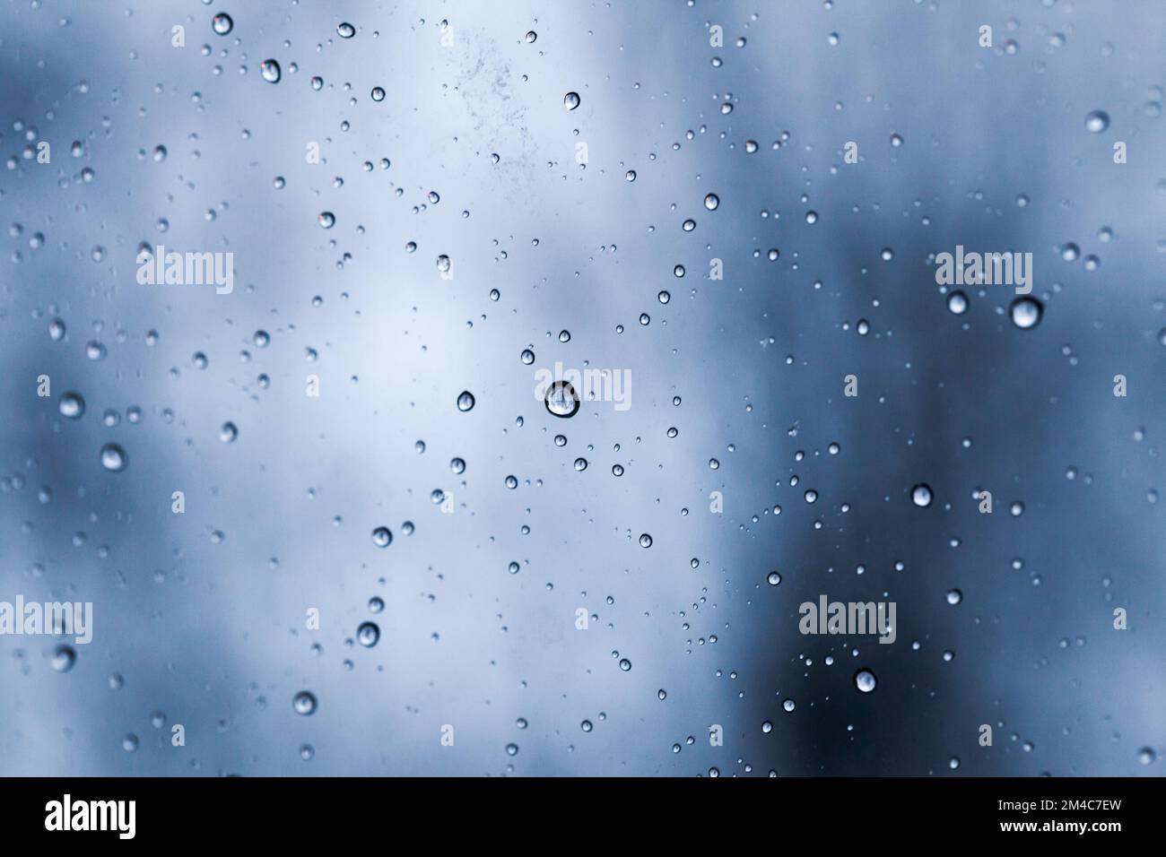 Water droplets are on a window glass on a rainy day, abstract background texture Stock Photo - Alamy
