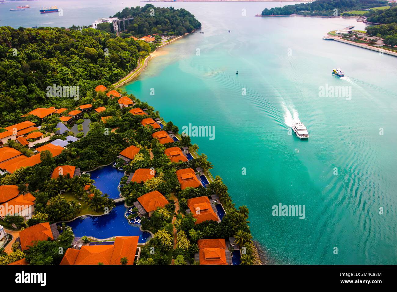The aerial view of boats on turquoise water and reddish building roofs ...