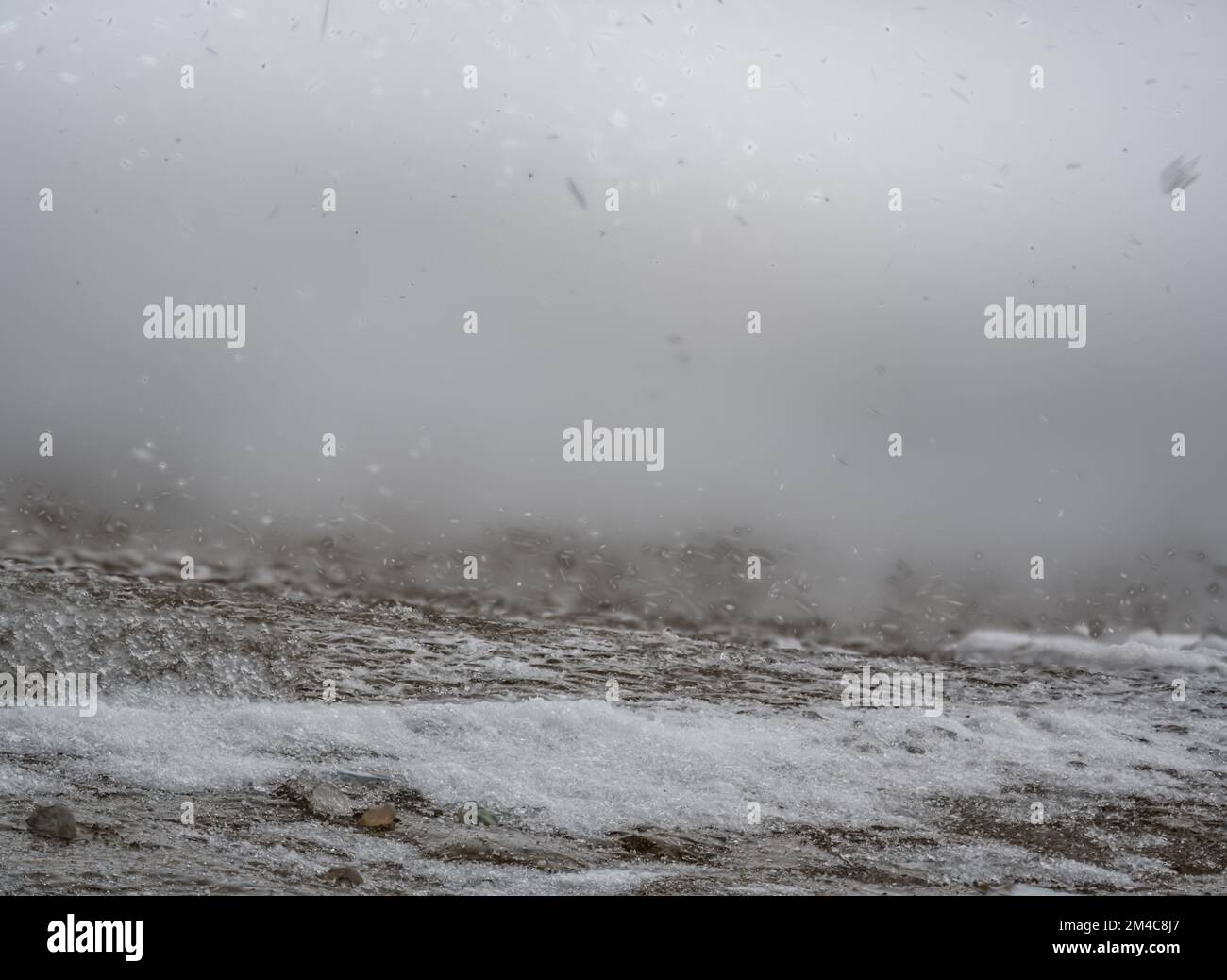 Focus stacked ground level view of ice accumulation on a sidewalk with ...