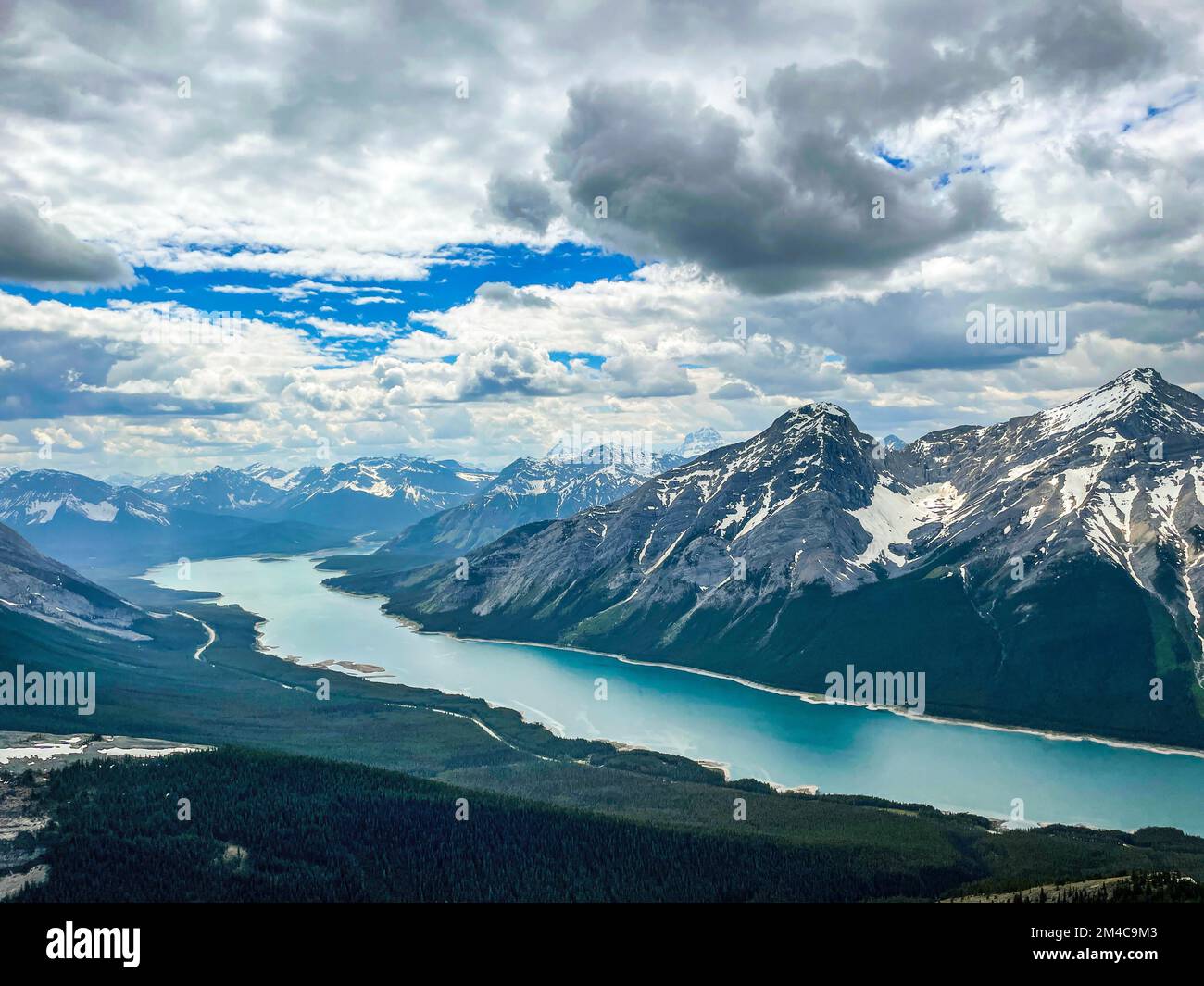 A mesmerizing view of a river, flowing between snowy mountain ranges ...