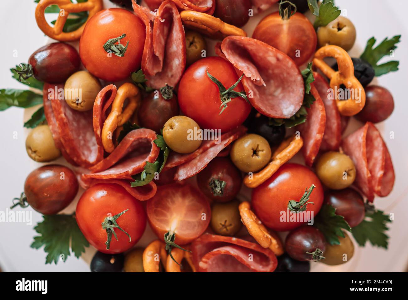 Salty cake with mushrooms decorated with vegetables and salami Stock ...