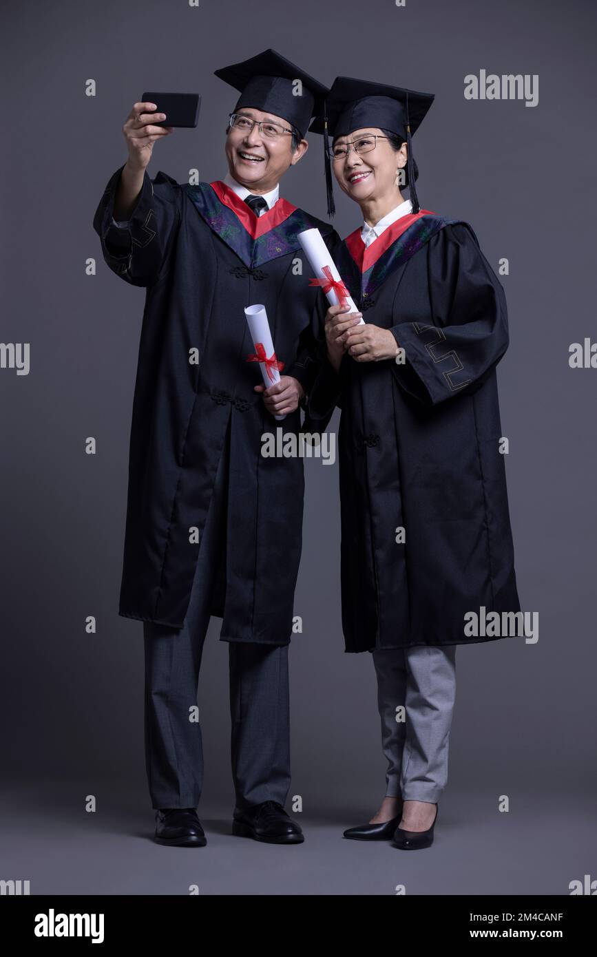 Senior Chinese students cheering for graduation Stock Photo - Alamy