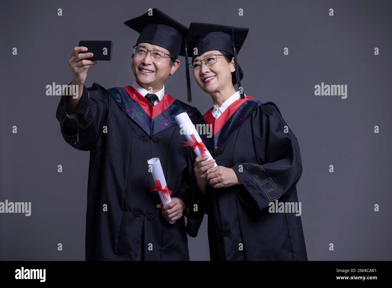 Senior Chinese students cheering for graduation Stock Photo - Alamy