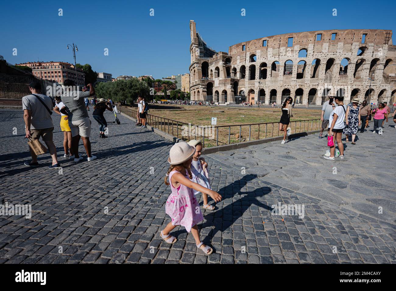 Rome, Italy - July 27, 2022: Two sisters walking against Colosseum or ...