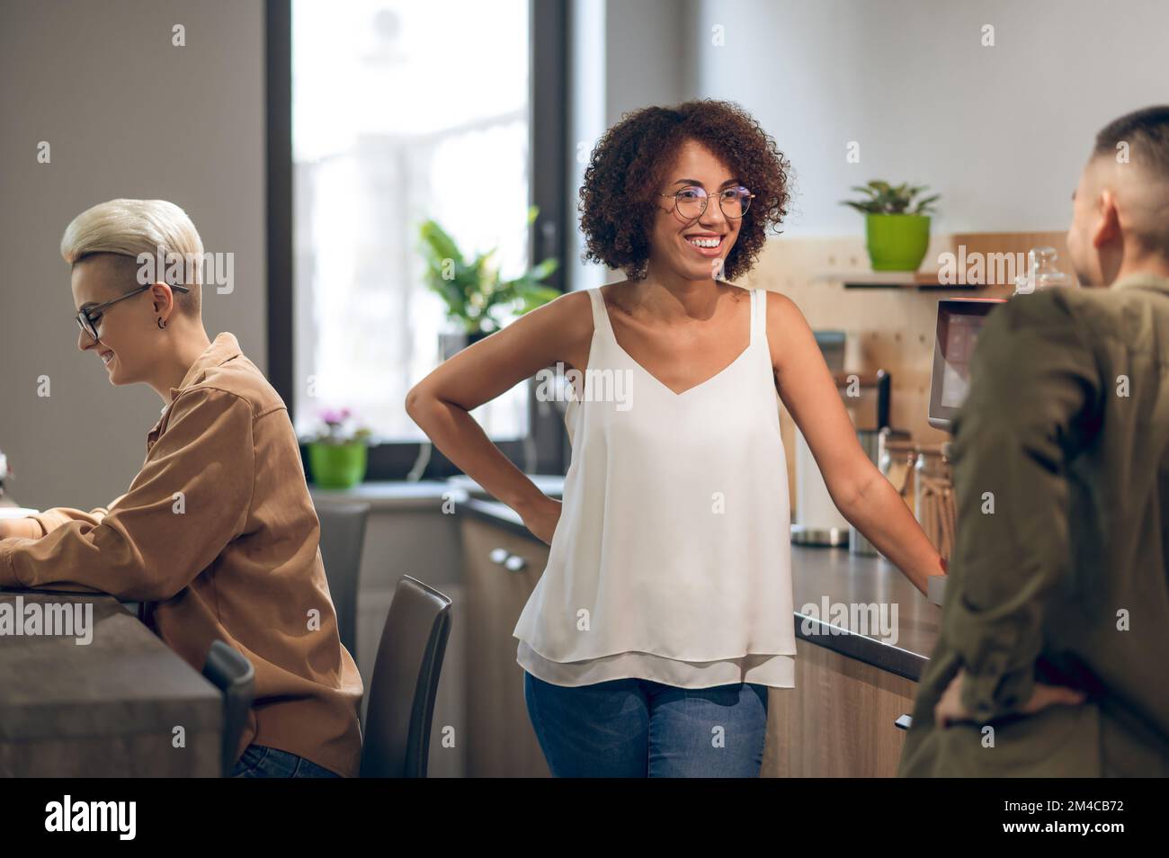 Group of office employees in the company kitchen Stock Photo - Alamy