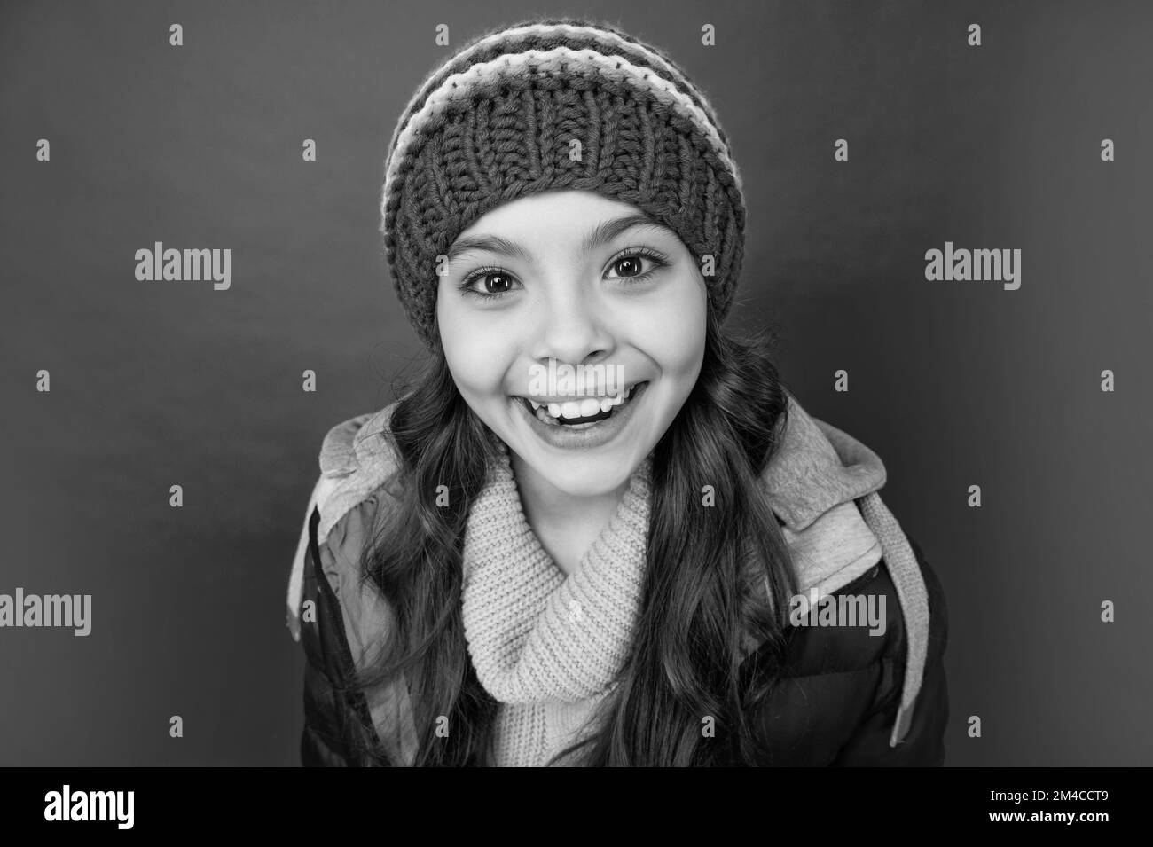 winter fashion. happy kid with curly hair in hat. female fashion model ...