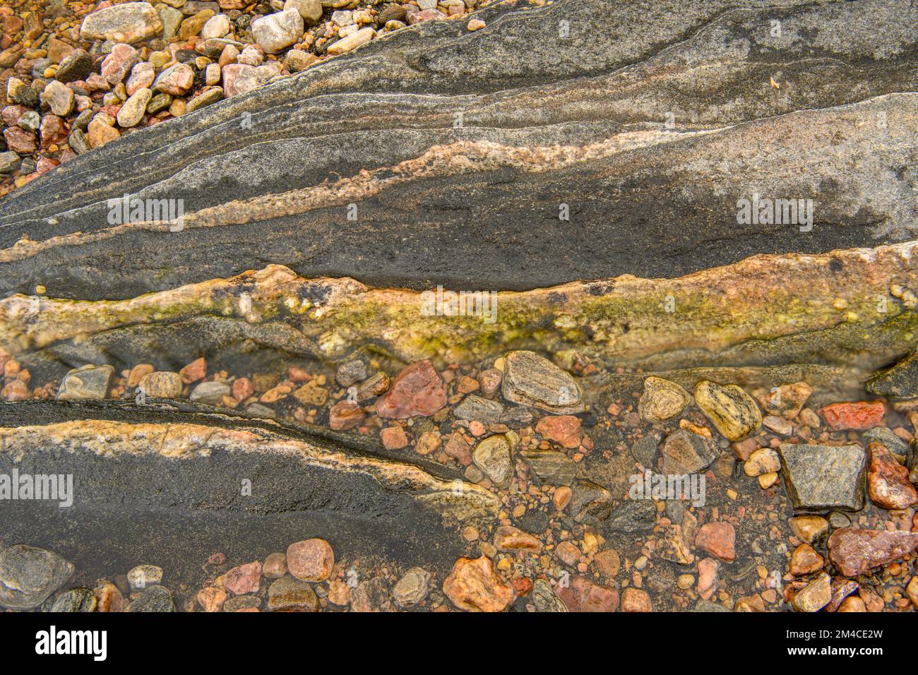 Melting ice, shoreline granite rock on Georgian Bay in early spring ...
