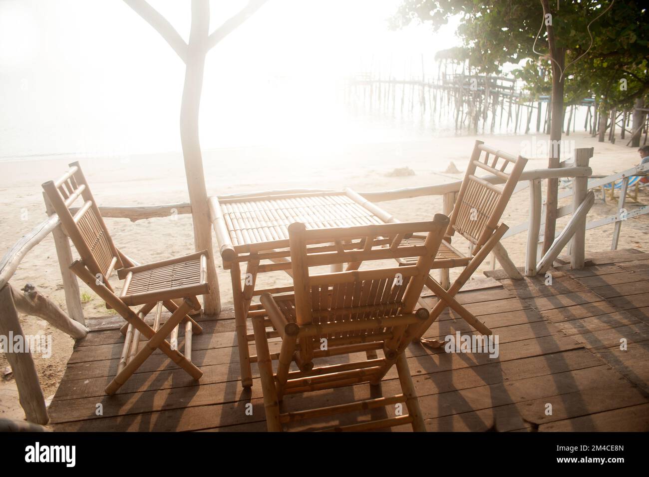 Chairs and table sitting under the eaves Stock Photo - Alamy