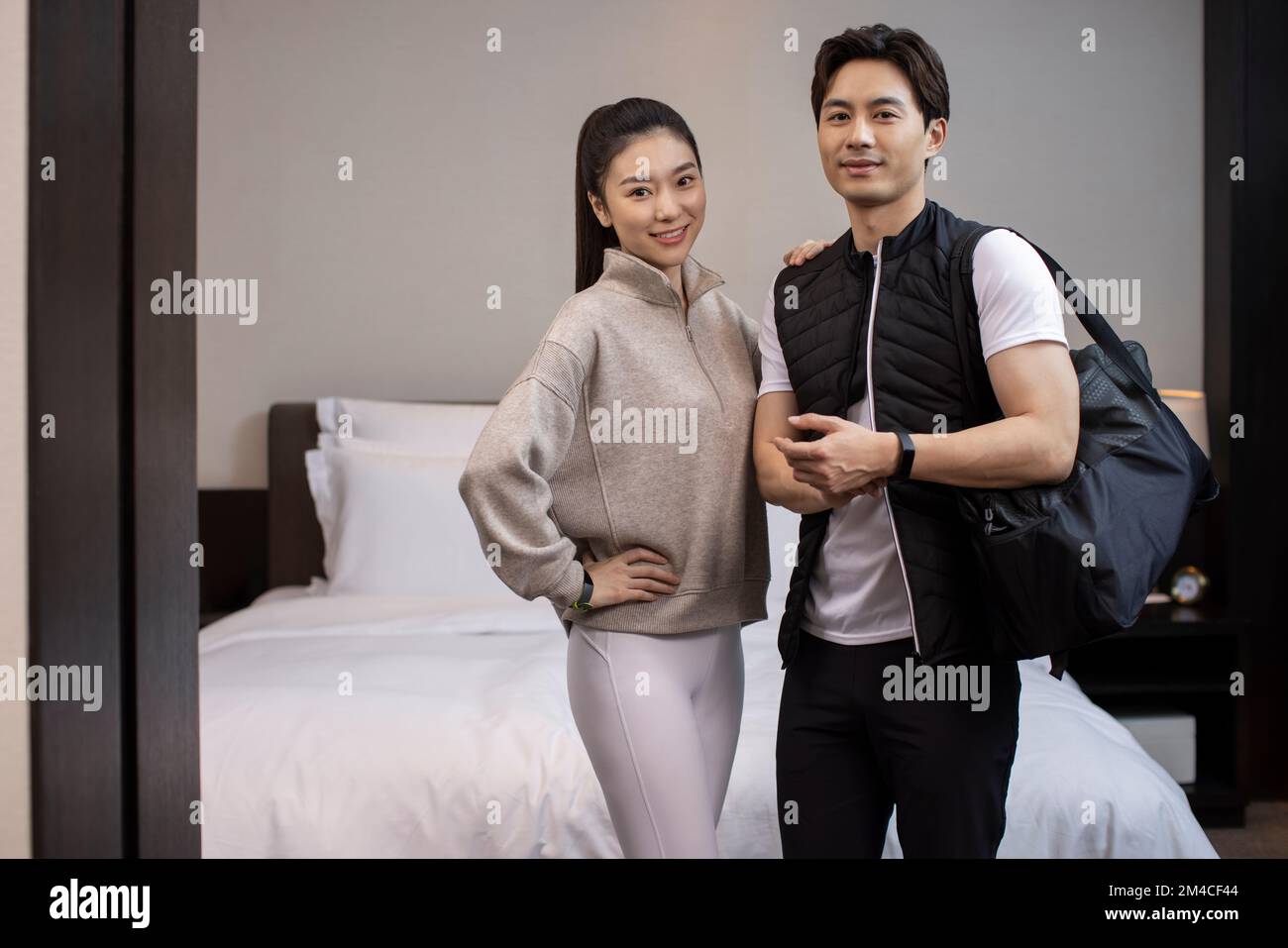 Young Chinese couple getting ready to go out and workout Stock Photo ...