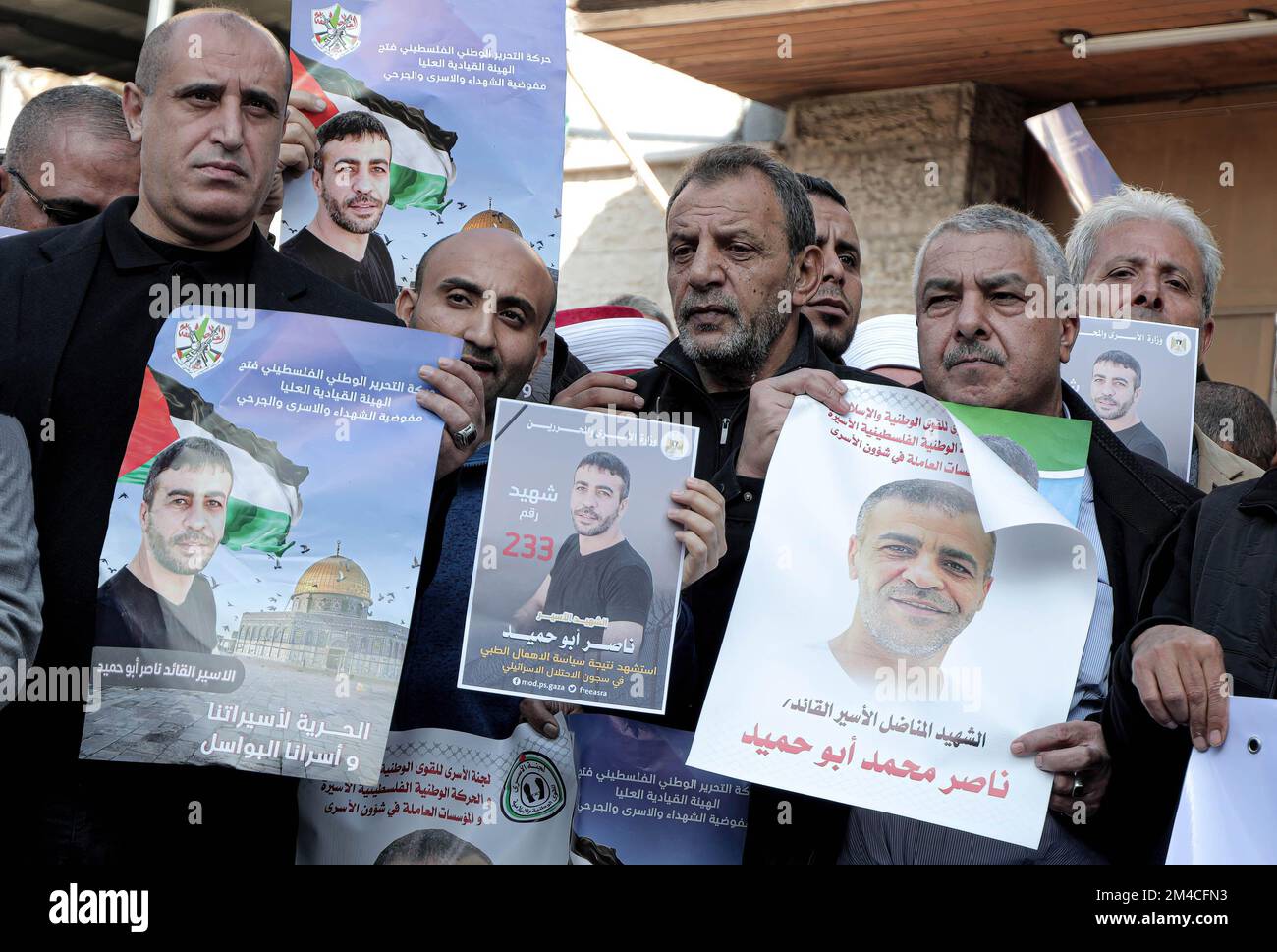 Protesters hold posters with pictures of the deceased Palestinian ...
