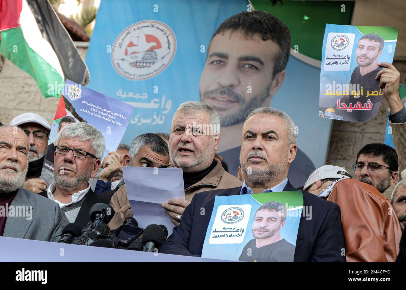 Protesters hold posters with pictures of the deceased Palestinian ...