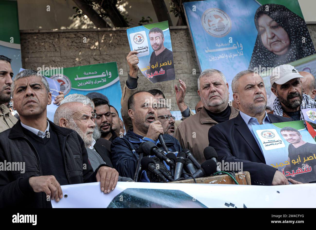 Protesters hold posters with pictures of the deceased Palestinian ...