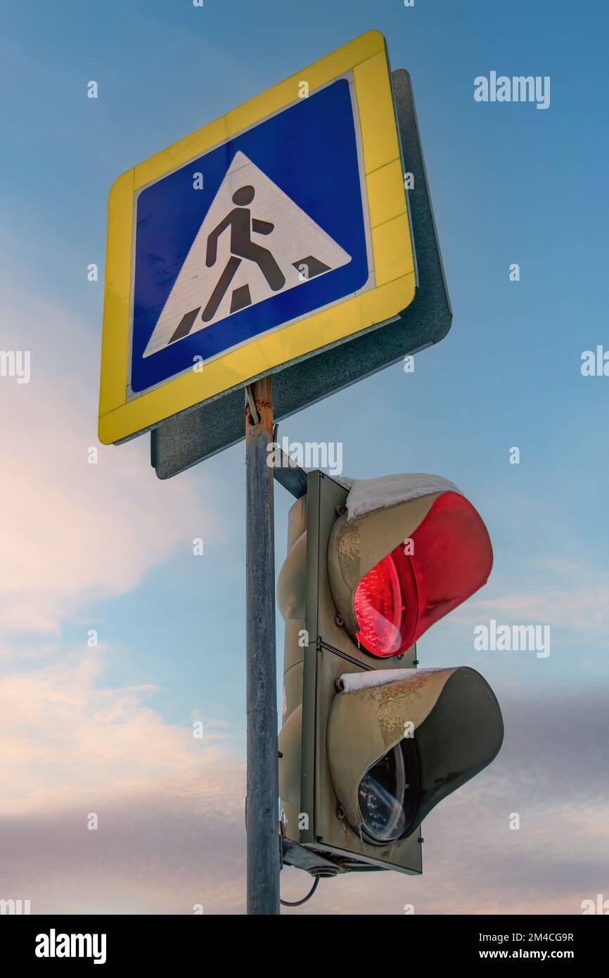 Red color on the traffic light with a beautiful blue sky in background ...
