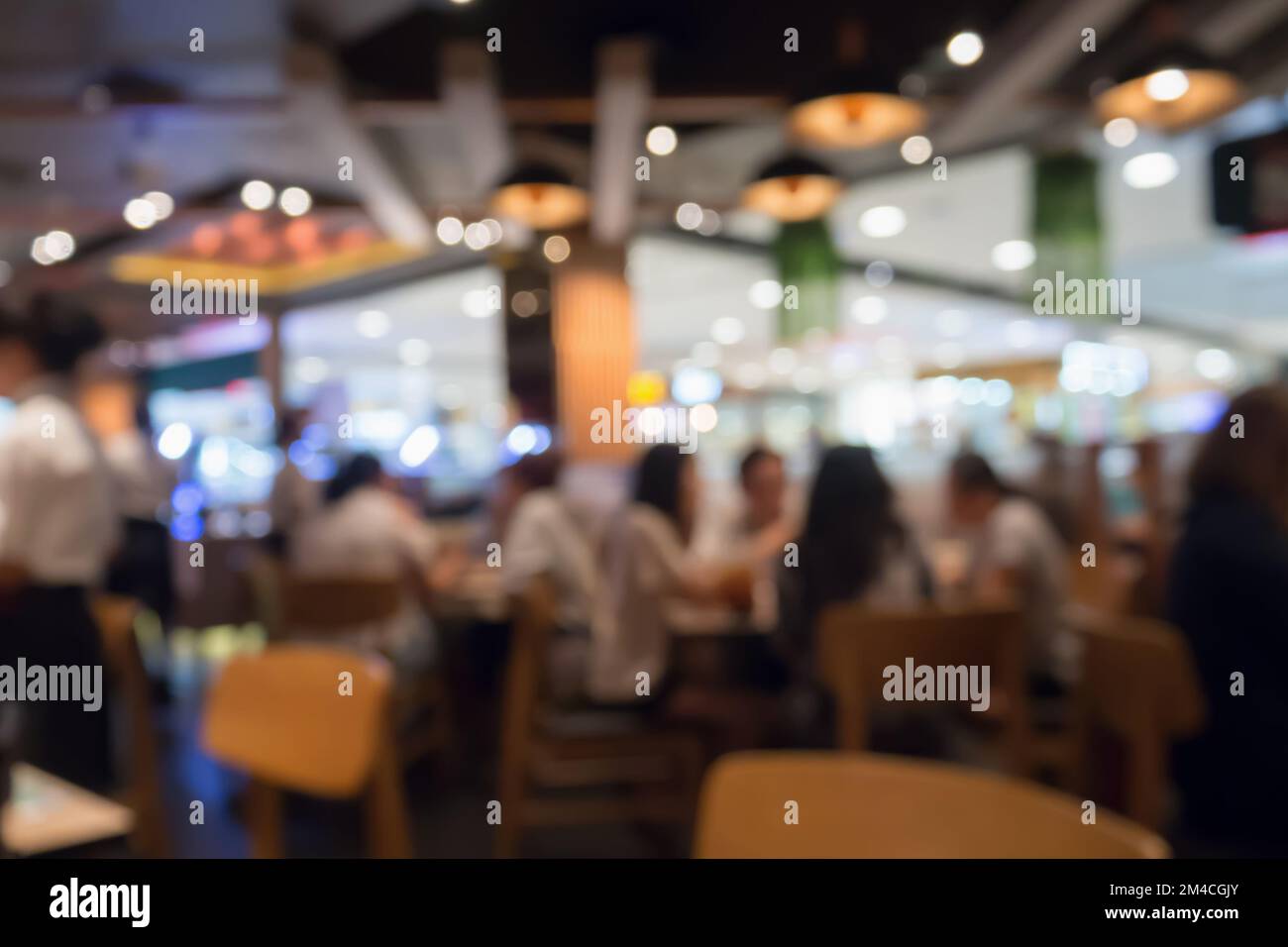 People in restaurant cafe or coffee shop interior with bokeh light ...