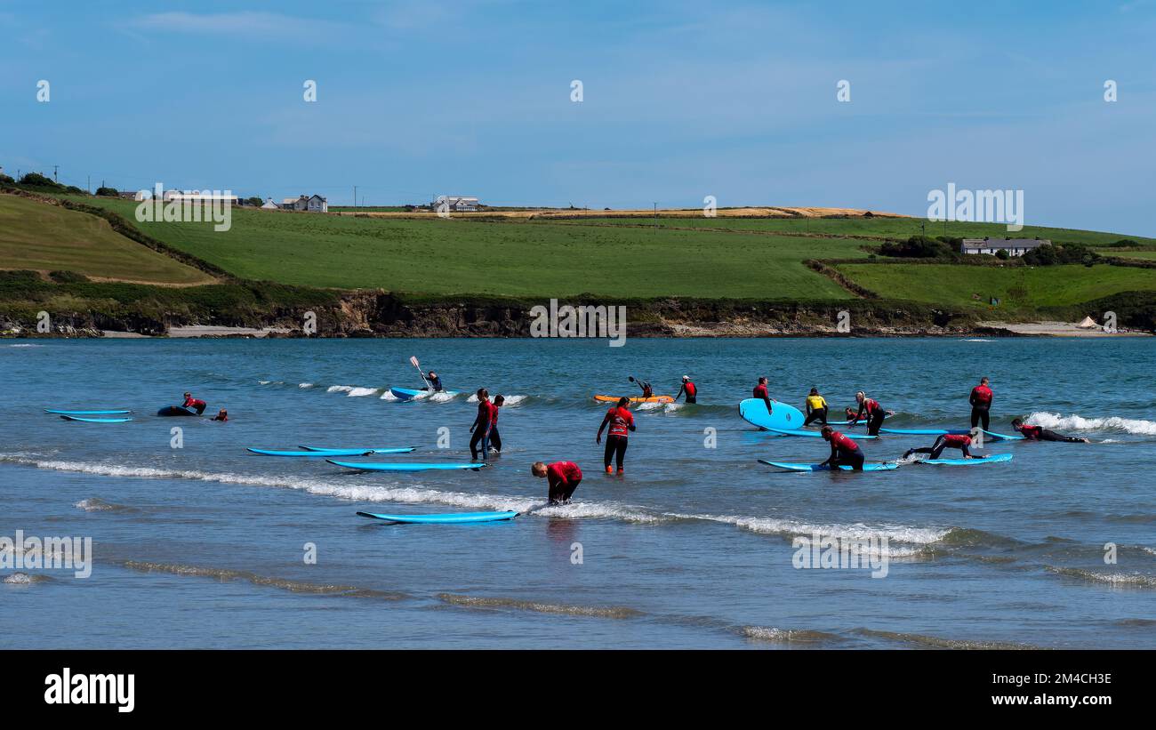 County Cork, Ireland, August 6, 2022. people are surfing. A surf school ...