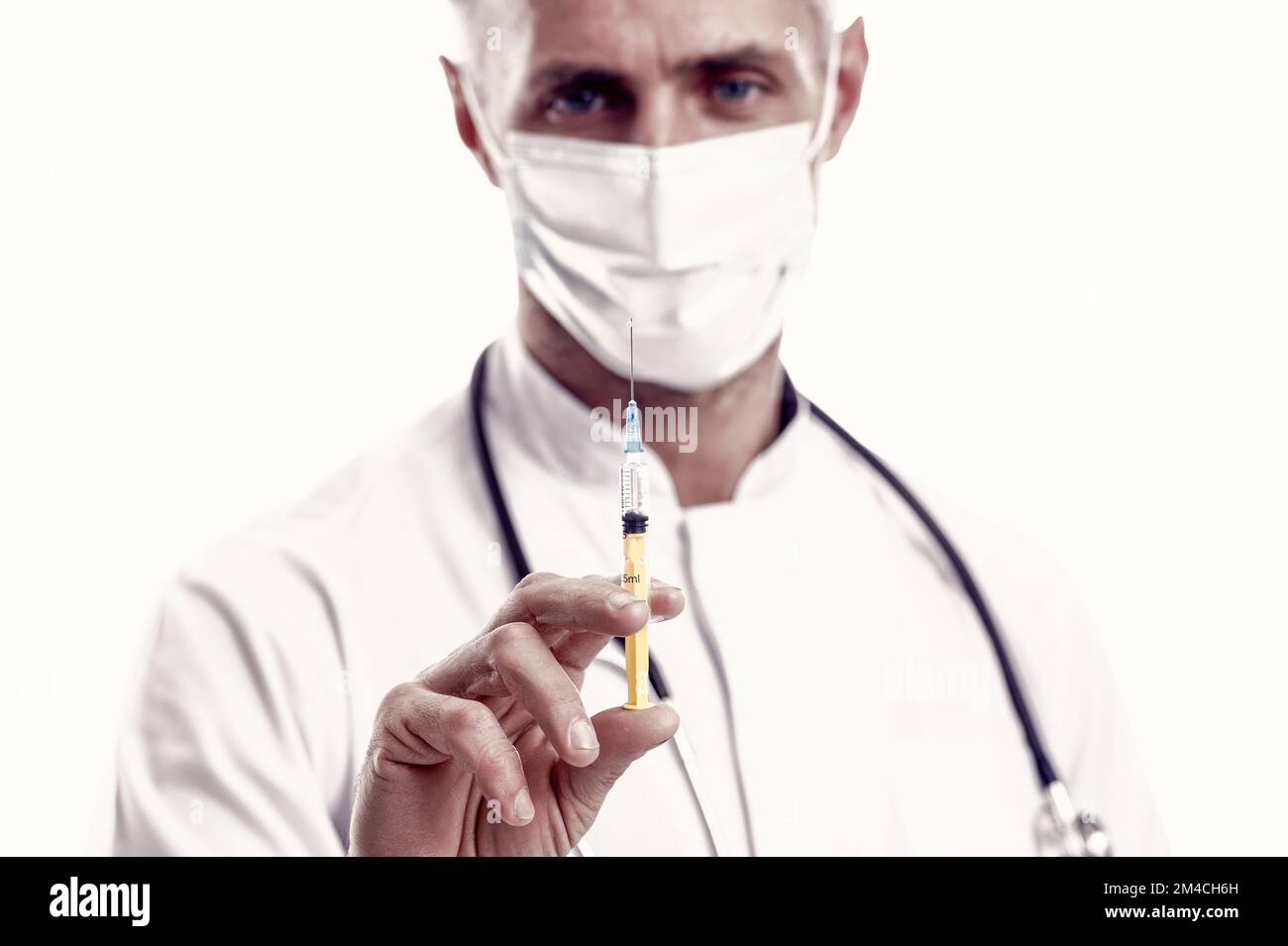 Syringe with needle selective focus in hands of physician for Covid-19 ...