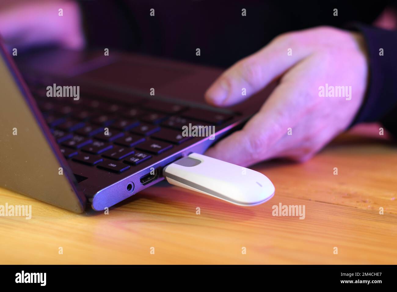 laptop with connected gsm modem on table and pink background Stock ...