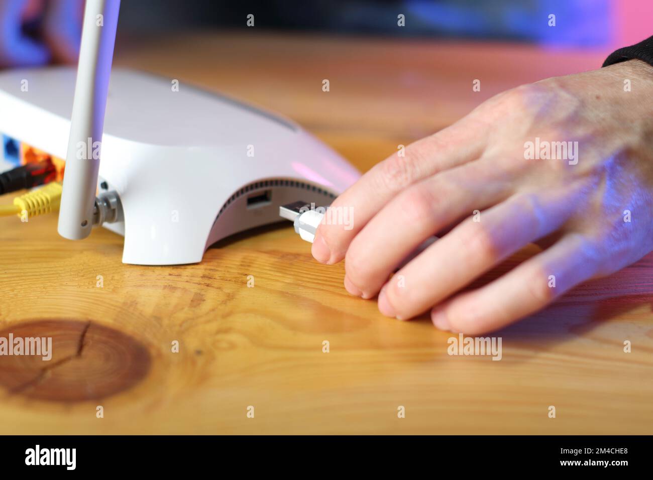 inserting gsm modem into router with antennas on plank table by sosba ...