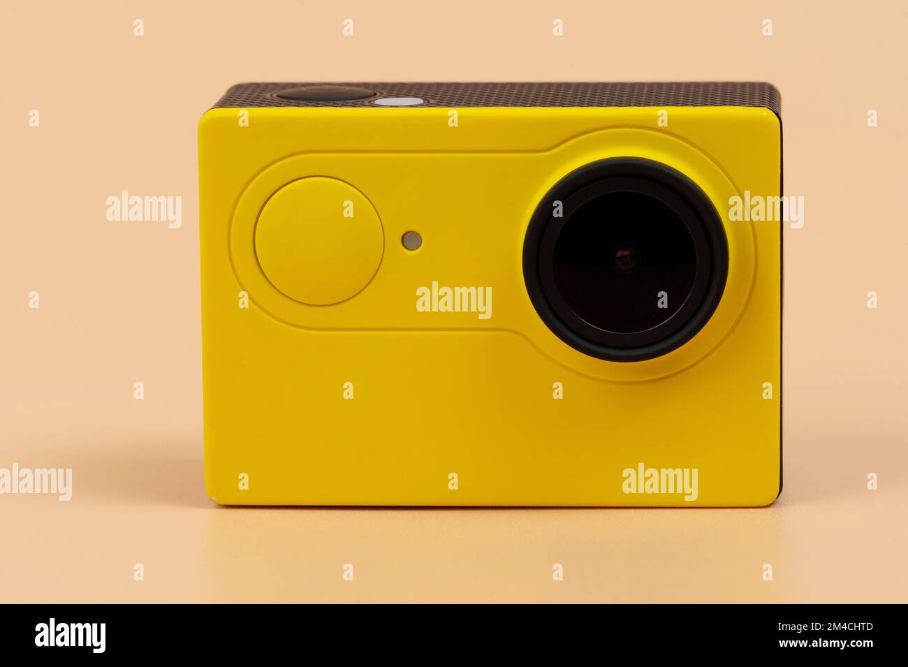 Yellow action camera front view isolated on brown background Stock ...