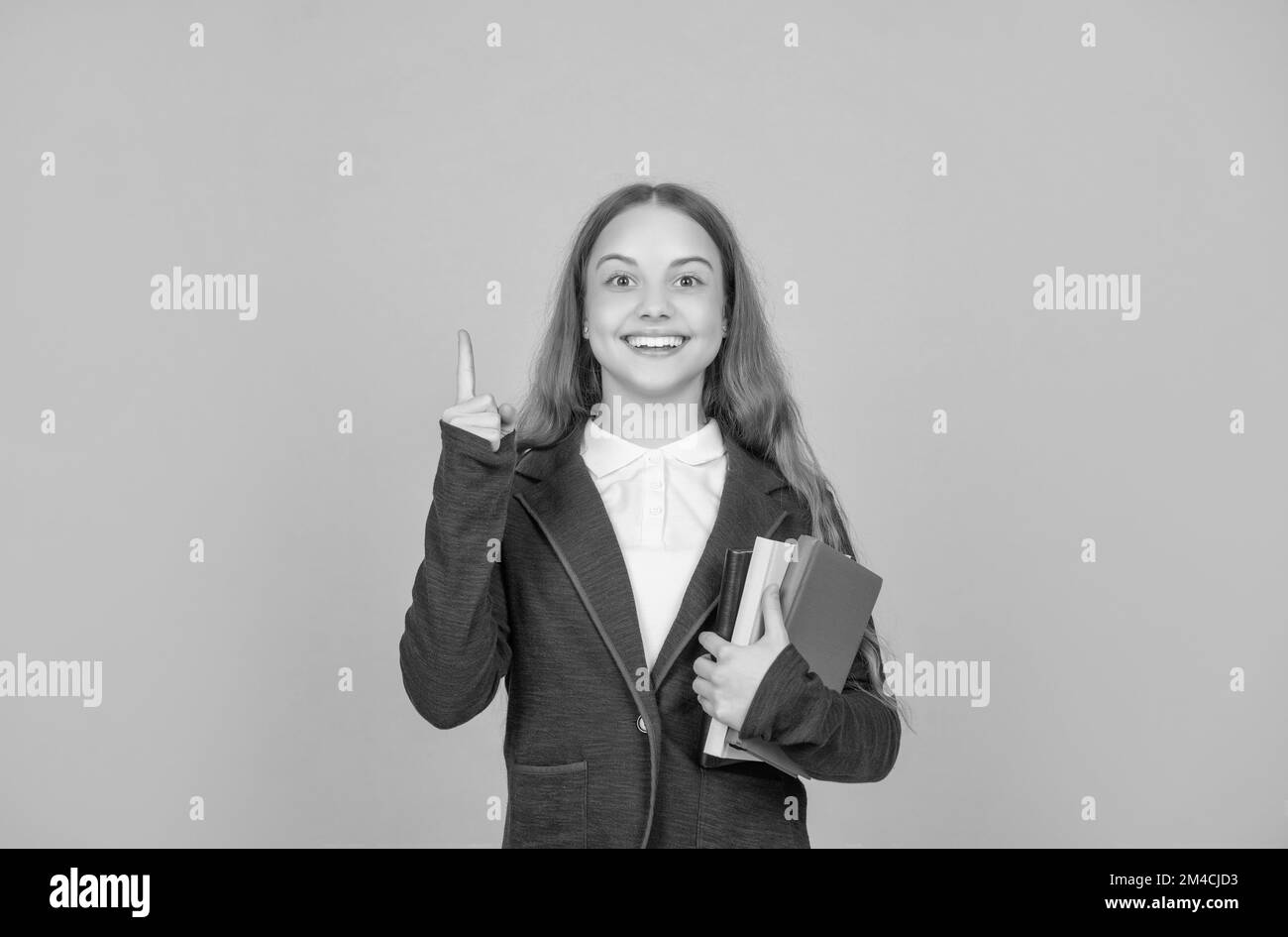 inspired with idea happy kid hold school homework on yellow background ...