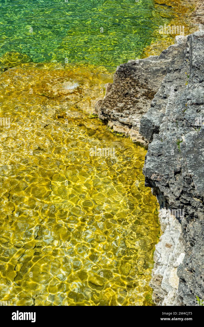 Sunlit water, rocks along the Lake Huron shoreline, Bruce Peninsula ...