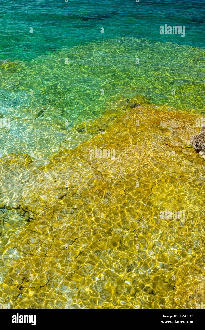 Sunlit water, rocks along the Lake Huron shoreline, Bruce Peninsula ...