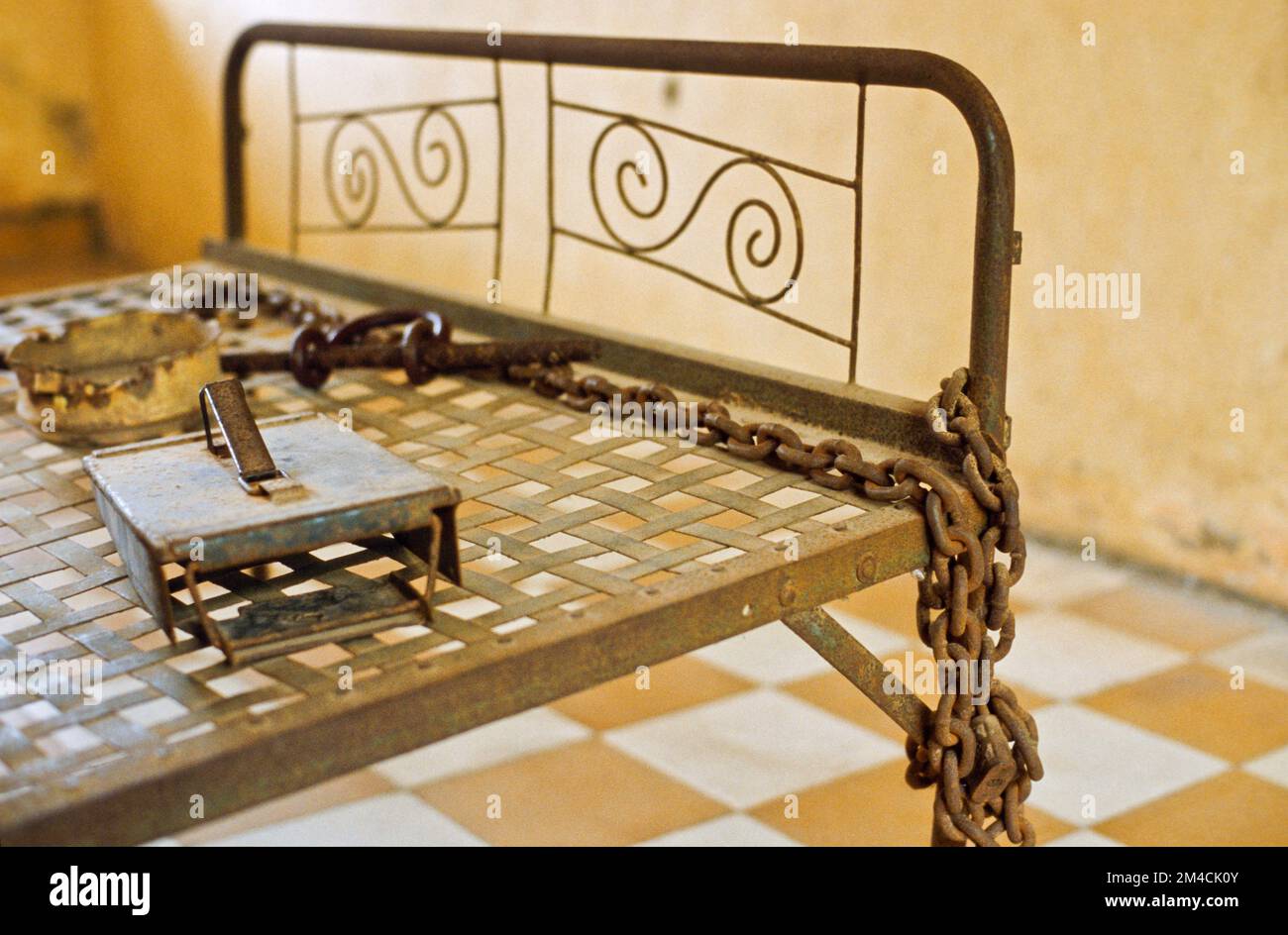 Steel bed and shackles in the Tuol Sleng Genocide Museum, former Tuol ...