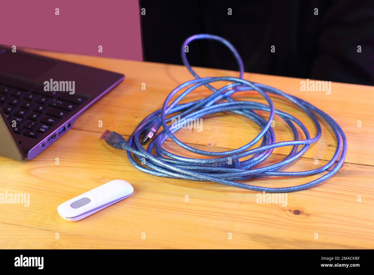 blue long usb cable on table next to laptop and card modem Stock Photo ...