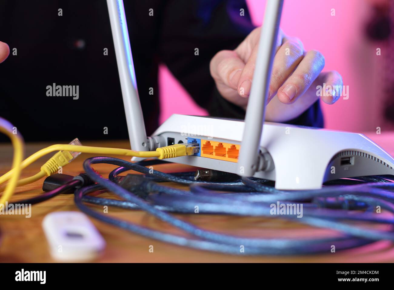 router with cable connected backwards ports on person and colored ...