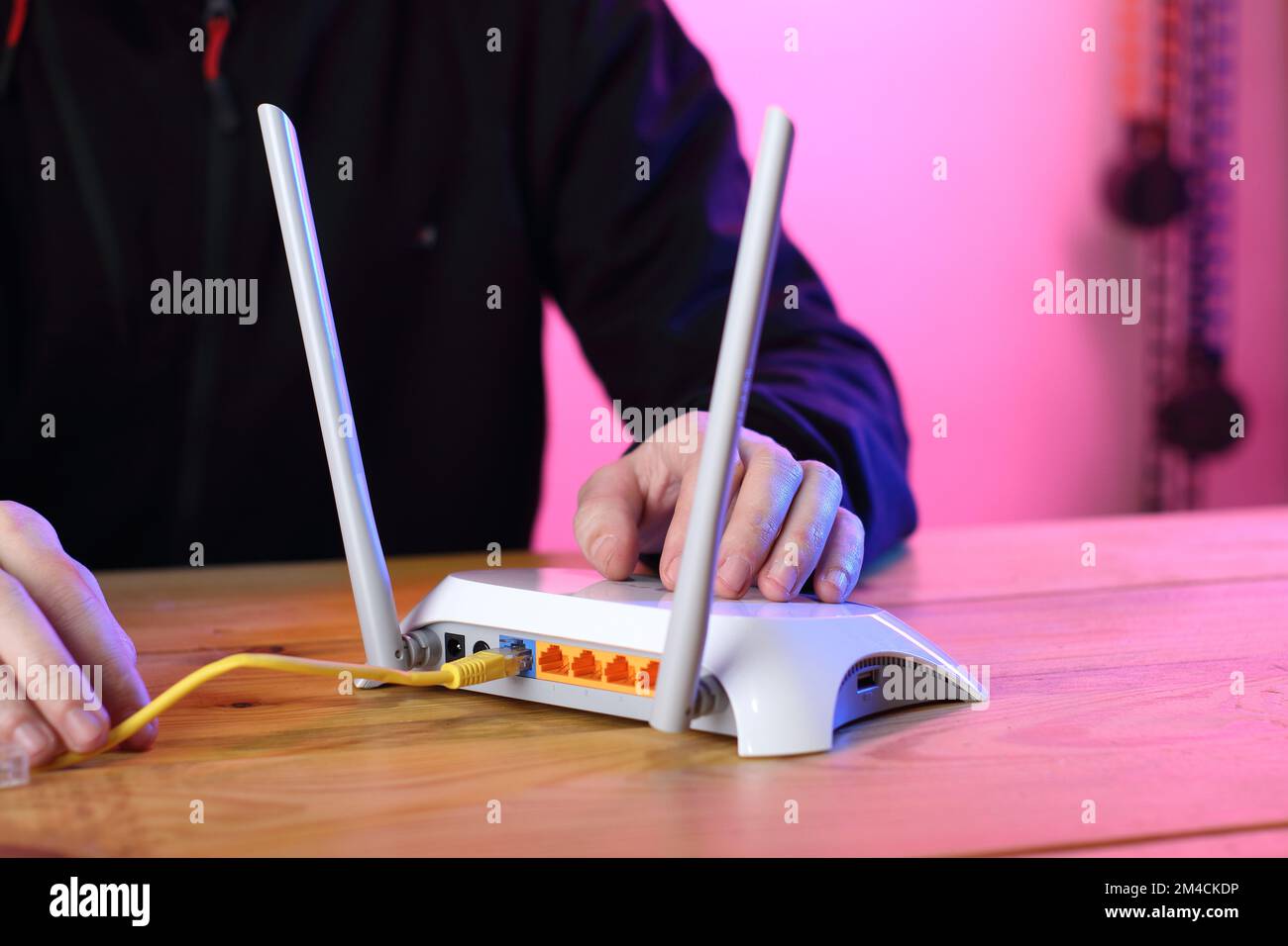 router with cable connected backwards ports on person and colored ...