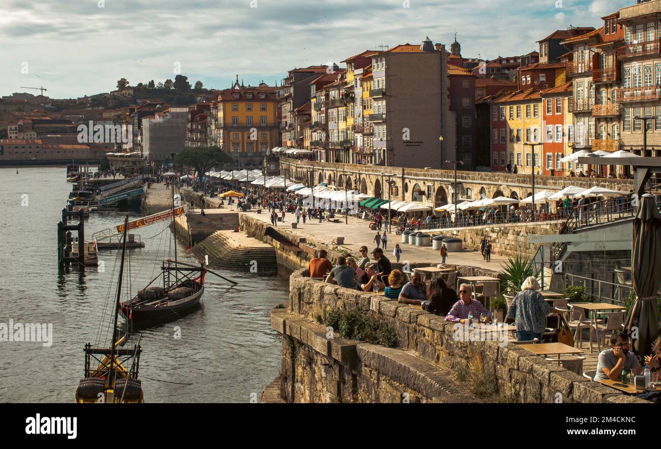 Promenade in Porto, people walk, relax and swim in boats Stock Photo ...