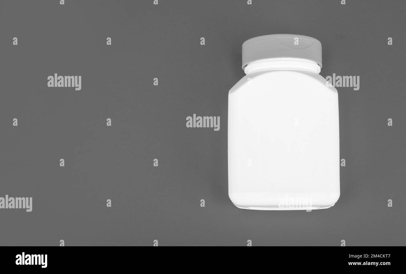 pill jar white color on blue background with copy space, vitamin Stock ...